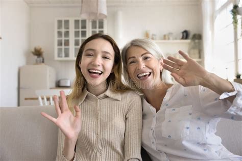 Happy Mature Mother With Teen Daughter Talking On Videocall Stock Image