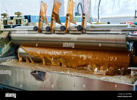 Efficient Hot Glue Application Process With Specialized Glue Spreading Machine In Action At A