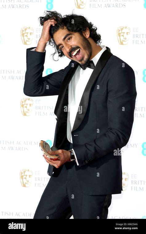 Dev Patel Winner Of The Best Supporting Actor Award Poses In The