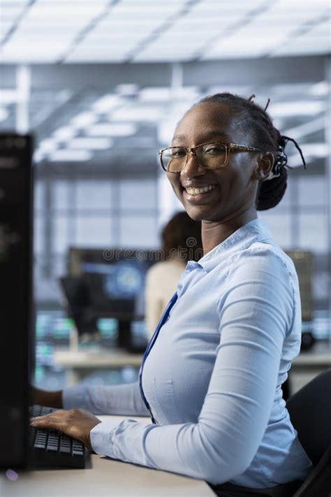 Portrait Of Smiling Technician In Data Center Testing Equipment Stock