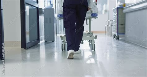 Patient Bed And Nurse Walking In Hospital With Feet Or Steps In