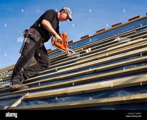 Self Building House Constructing Roof Man Fixing Roofing Laths With