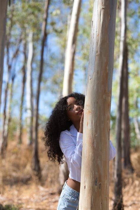 A Young Beautiful Latin Brunette Woman With Curly Hair Is Holding On