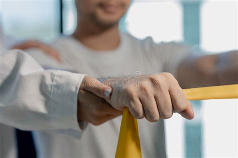 A Physical Therapist Is Helping A Patient With Basic Physical Therapy