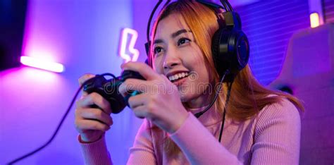 Gamer Using Joystick Controller Plays Online Video Game With Computer Neon Lights She Winning