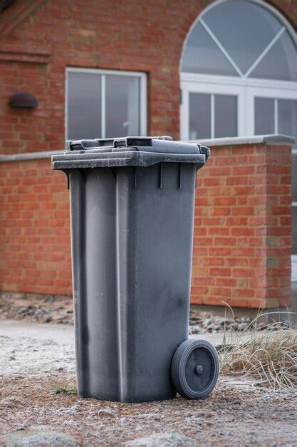 Premium Photo Garbage Bin Against Building Premium Photo Garbage Bin Against Building