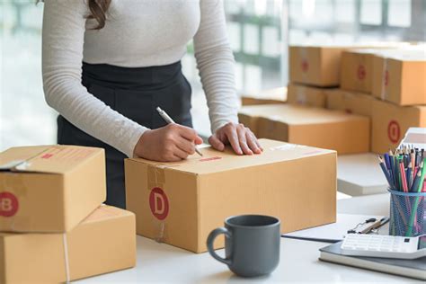 온라인 판매 비즈니스 소유자 여성은 배달을 위해 준비되는 소포 상자에 고객의 주소를 기록하고 있습니다 고객에 대한 스톡 사진 및 기타 이미지 Istock