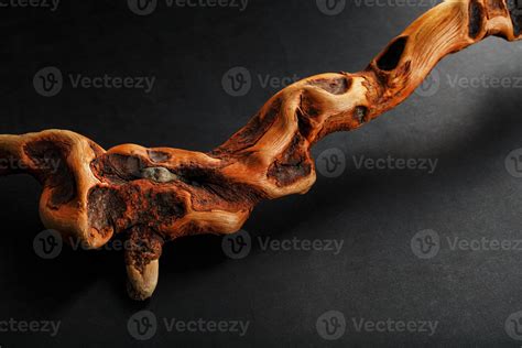 Textured Curved Wooden Snag Of Brown Color With Texture On A Black Background With Free Space