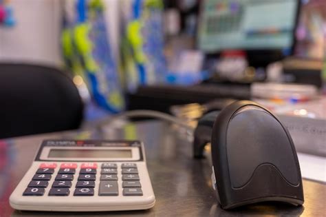 Premium Photo Qr Code Scanner On Table With Calculator With Casheer Screen In The Background