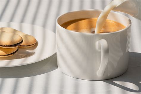 아침 햇살에 부엌 테이블에 커피와 쿠키 한 잔닫고 우유를 붓습니다 커피잔에 대한 스톡 사진 및 기타 이미지 커피잔 쿠키