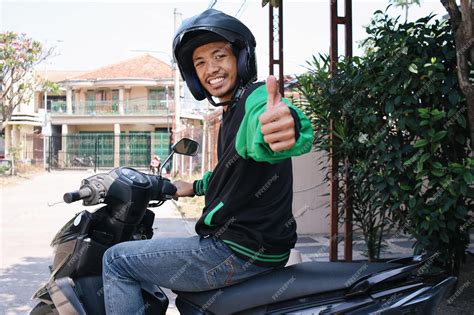 Premium Photo Happy Online Motor Driver Showing Thumb Up To Camera
