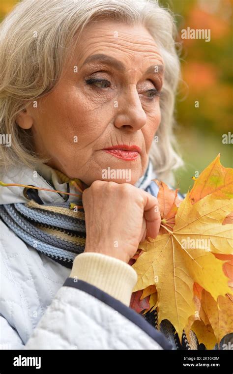 Senior Sad Woman In The Park In Autumn Stock Photo Alamy