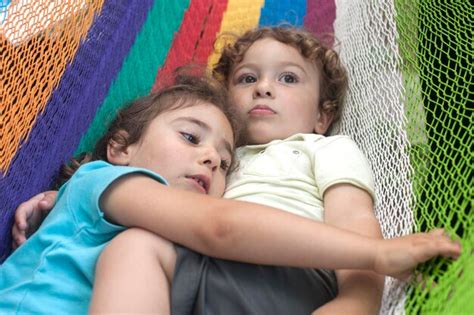 Premium Photo Boy Relaxing With Sister In Hammock
