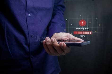 Man Holding A Smartphone With Memory Space Full Notification On Virtual Screen Stock Image