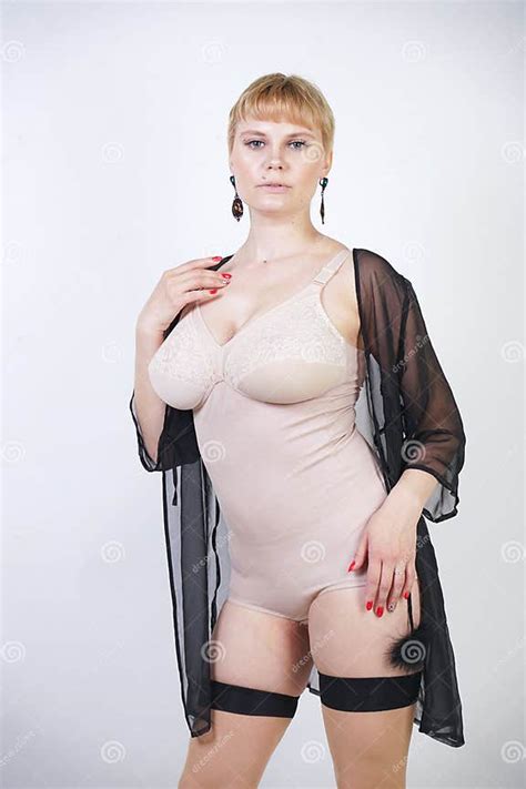 Pretty Blonde Short Hair Retro Woman With Curvy Body Posing In Beige