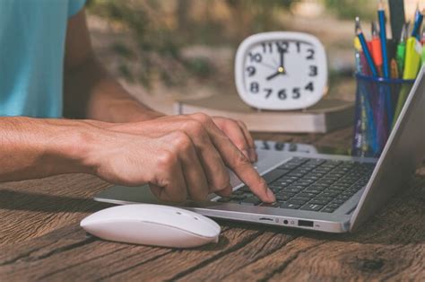 Premium Photo Man Using Laptop On A Wooden Table