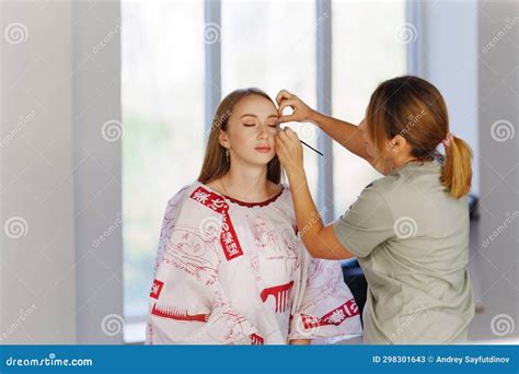 Professional Makeup Artist Doing Makeup For Redhead Beautiful Woman In