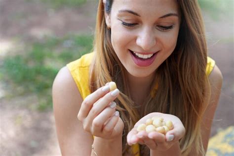 Premium Photo Beautiful Girl Eating Macadamia Nuts Outdoor Looks At