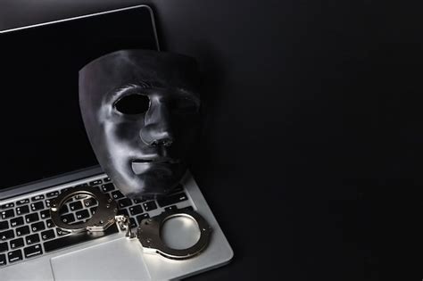 Premium Photo Dangerous Anonymous Hacker Man In Black Hooded Using Computer Breaking Into