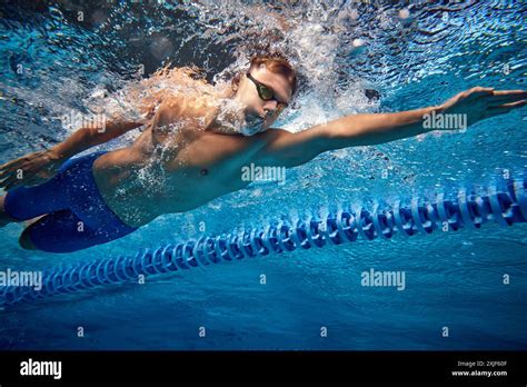 Dynamic Underwater Image Of Man Swimming Freestyle His Muscular Arms