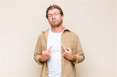 Premium Photo Blonde Man Pointing To Self With A Confused And Quizzical Look