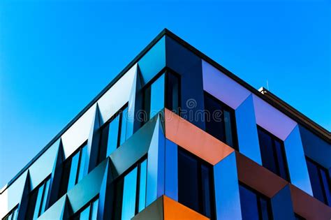 Abstract Close Up Of Modern Building Facade With Angular Patterns And Reflective Blue Windows