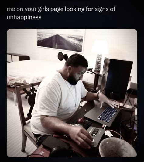 A Man Sitting In Front Of A Laptop Computer