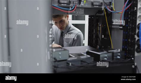 Technician Performing Maintenance Tasks In A Server Room Rack Stock Photo Alamy