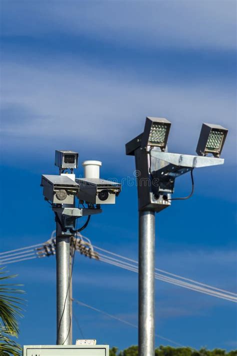 Urban Surveillance And Traffic Monitoring Cameras On Metal Poles In