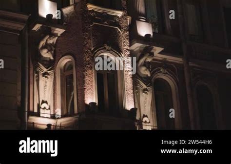 Building With Columns And Figures Of Nude Women Architectural Style Illumination Night Stock