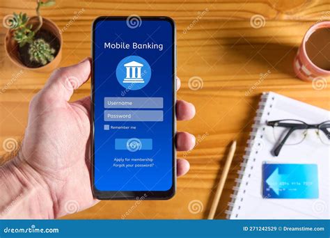 Male Hand Holding Mobile Phone With Online Banking App Interface On The