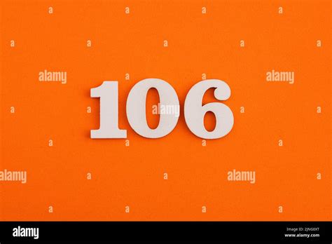 White wooden number 106 on eva rubber orange background Stock Photo - Alamy