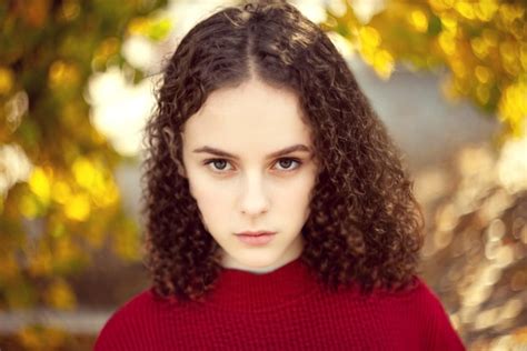 Premium Photo Portrait Of A Curly Brunette Girl Looking At The Camera