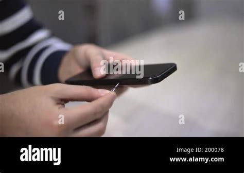 Unrecognized Person Removing Sim Card From Smartphone Closeup Of Man