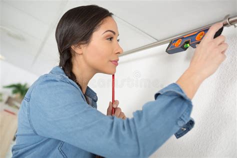 Lady Checking Curtain Rail With Spirit Level Stock Image Image Of Spirit Home 258968901