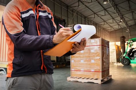Premium Photo Worker Holds A Clipboard Checking The Loading Cargo Shipment At Distribution