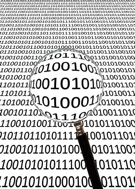 binary code and magnifying glass photograph by victor de schwanberg