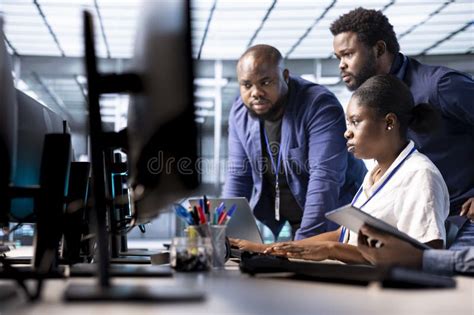 server hub it staff members debugging and optimizing code stock image
