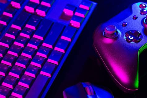 premium photo computer keyboard mouse and joystick on black background