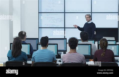 Teacher Speaking About Programming On Lecture In Computer Class Stock