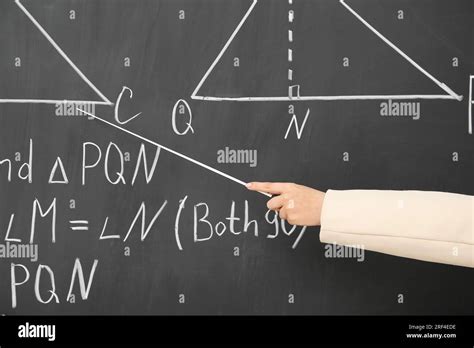 Female Teachers Hand With Pointer Explaining Math Formulas On