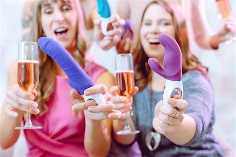 Premium Photo Cheerful Women Holding Dildos And Drinks