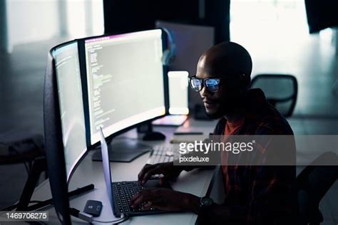 Black Man Developer Coding And Programming On Computer At Night In Software Or Application