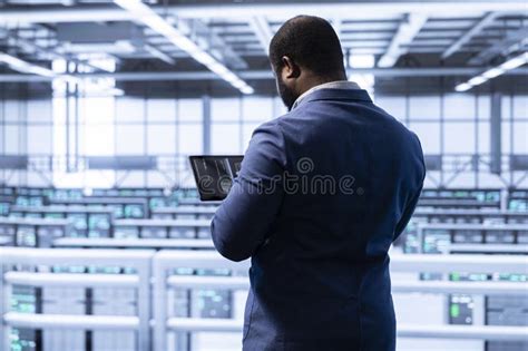 Programmer Using Tablet In Data Center To Do Disaster Recovery Planning Stock Image Image Of