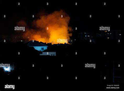 Night Fire In Residential Area With Cottage And High Rise Buildings In