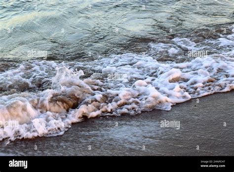 Detailed Close Up View On Water Surfaces With Waves And Ripples And The Sunlight Reflecting At