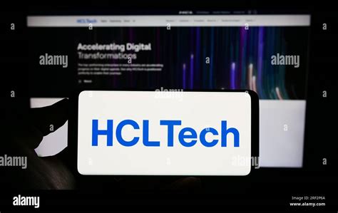 Person Holding Mobile Phone With Logo Of Indian Company Hcl Technologies Limited On Screen In