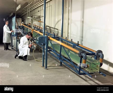 Fluid Dynamics Test Apparatus Researchers Preparing An Apparatus To Be