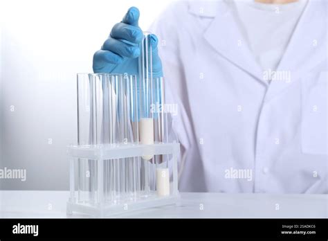 Laboratory Testing Scientist Working With Test Tubes At White Marble Table Closeup Stock Photo