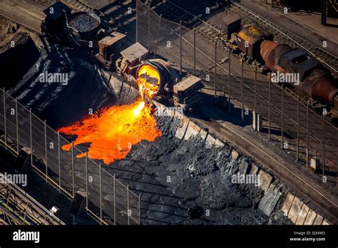 Hot Iron Production Slag Being Poured From A Barrel Into A Pit In The